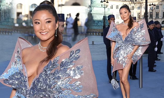 Emily In Paris star Ashley Park puts on a VERY busty display as she dazzles in a giant shiny bow ...